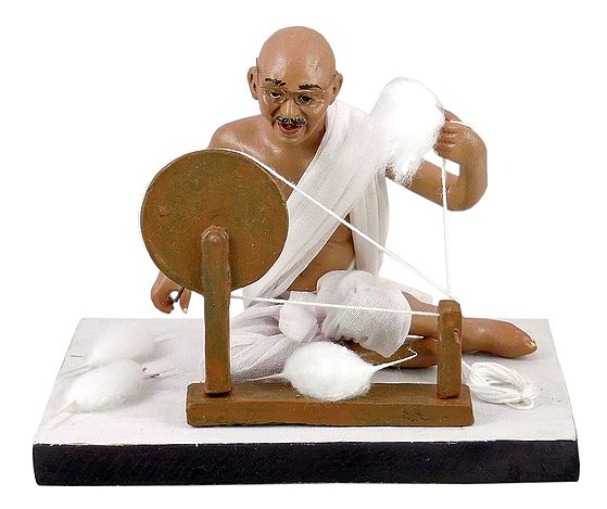 Mahatma Gandhi with his Charkha